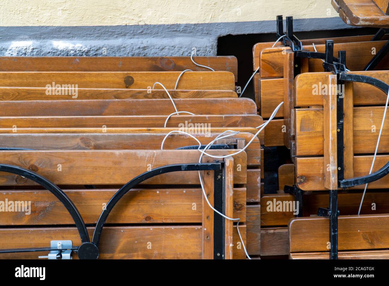 Tied together folded wooden restaurant tables Stock Photo - Alamy