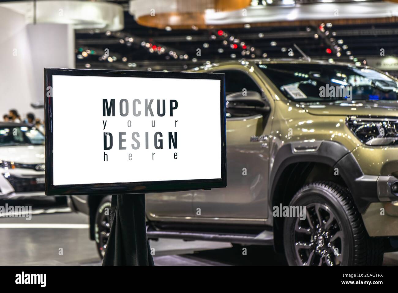 Mockup blank white screen LCD TV with blurred background of car in car ...