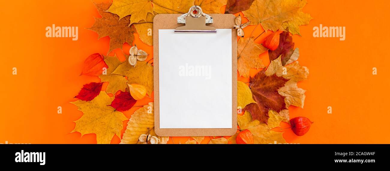 Autumn flat lay composition with clipboard mockup and dry leaves on ...