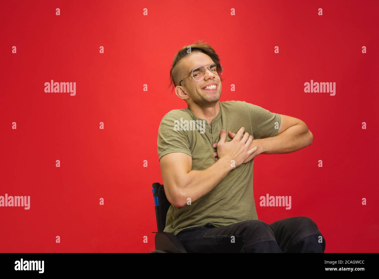 Fall in love, kind. Caucasian young disabled man's portrait on red ...