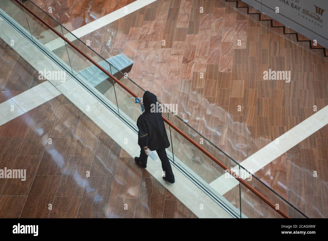 25.06.2020, Singapore, , Singapore - A worker is cleaning the handrail ...