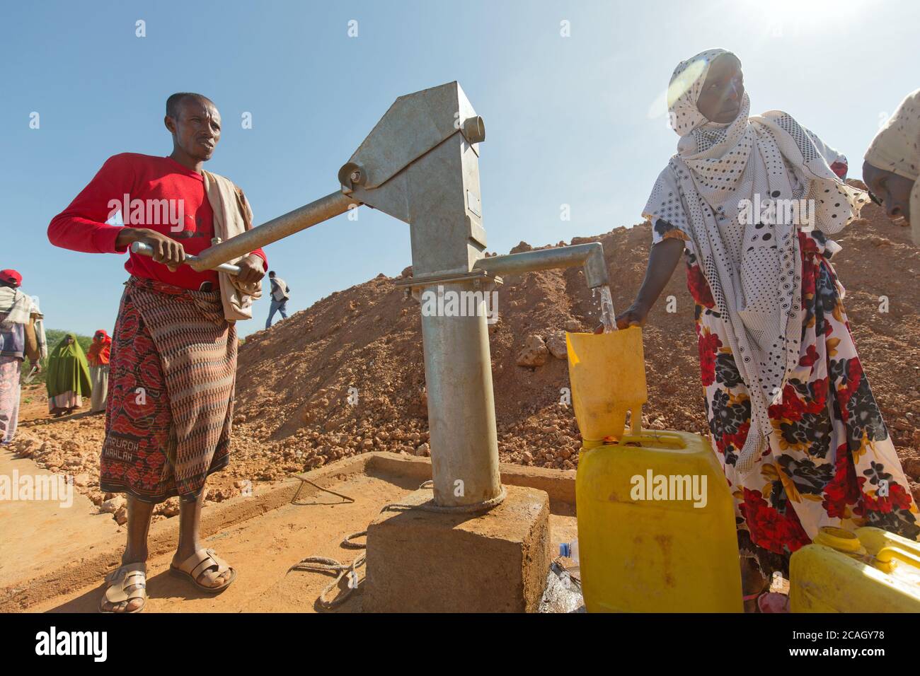 13.11.2019, Gabradahidan, Somali Region, Ethiopia - Women filling yellow water canisters at a ...