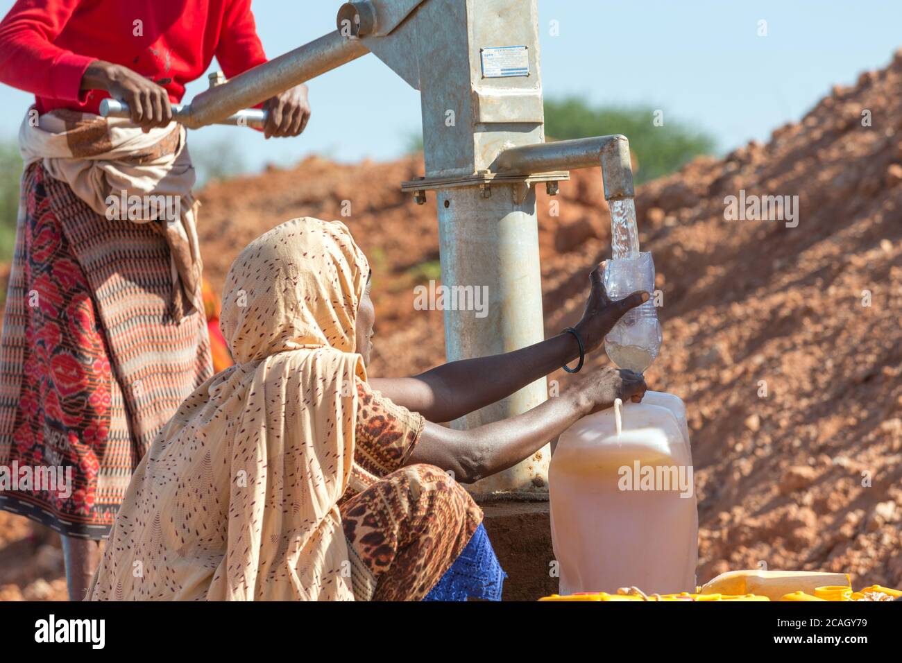 13.11.2019, Gabradahidan, Somali Region, Ethiopia - Women filling yellow water canisters at a ...