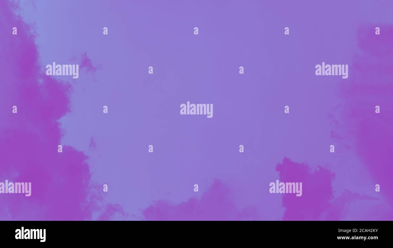 Violet purple sky background with fluffy clouds. Copy space, panorama ...