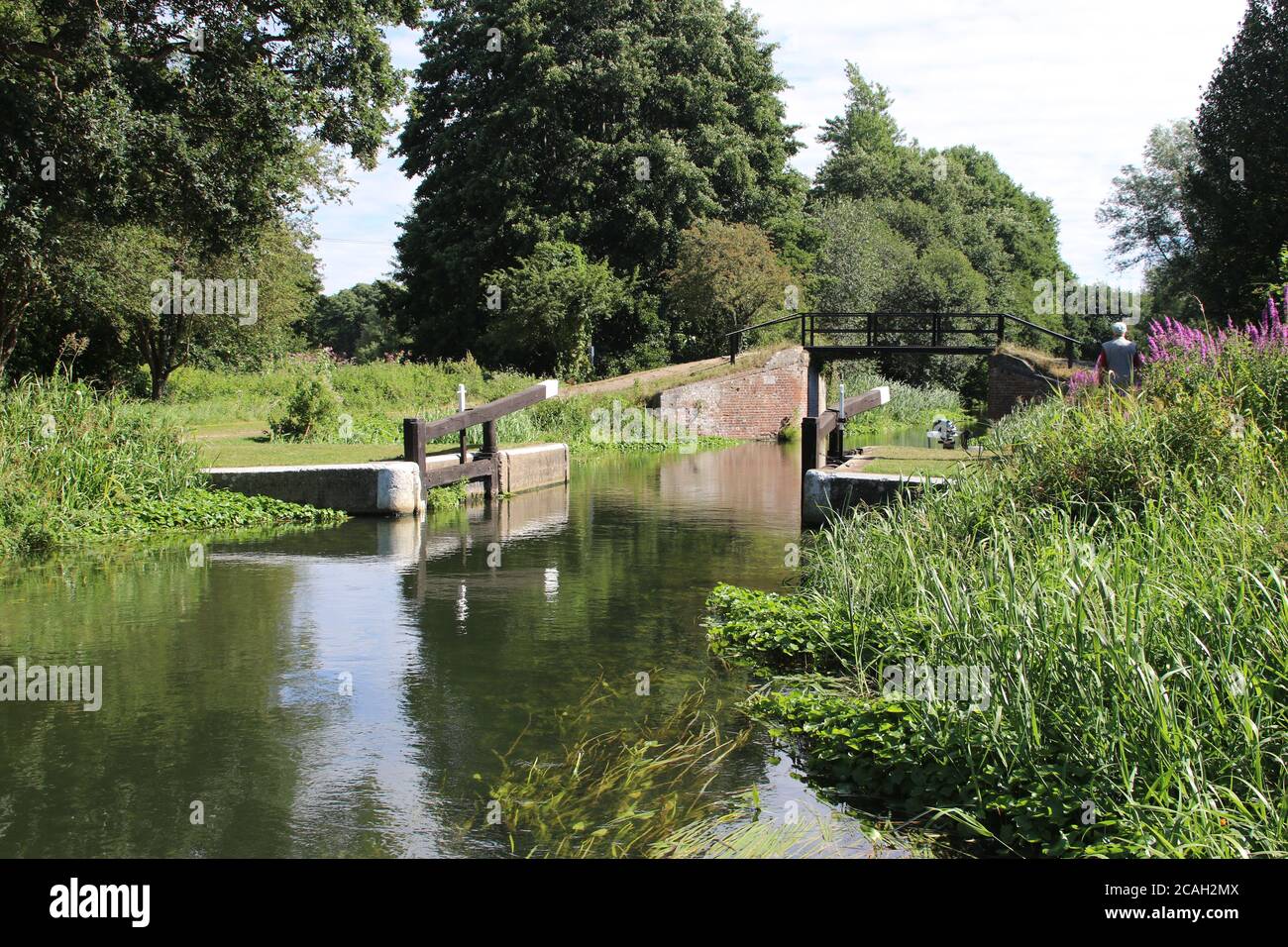 a scenic stretch of river in summer with a bridge over the water Stock ...