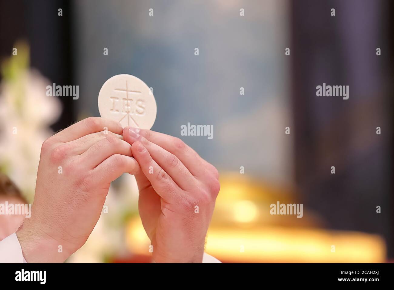 Holy host in the hands of the priest on the altar during the ...