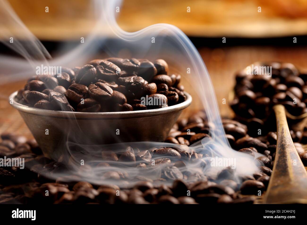 Roasted coffee and smoke on a brown background and empty space for text ...