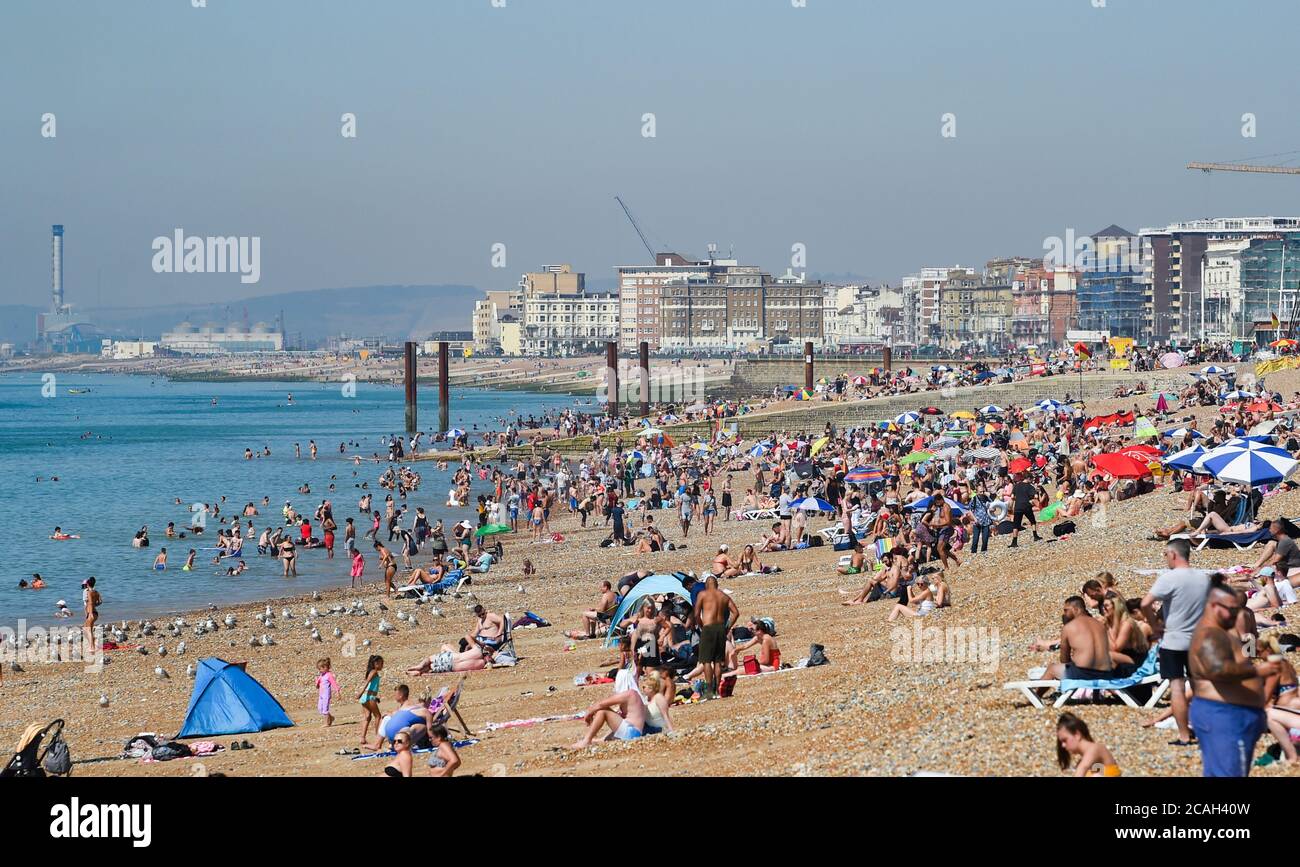 Brighton UK 7th August 2020 - Crowds flock to Brighton beach as they ...