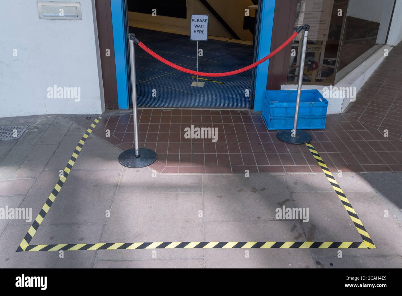 Social distancing tape markings and a book drop-off box outside Shoe ...