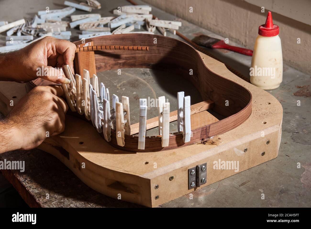 Luthier making an acoustic guitar body Stock Photo - Alamy