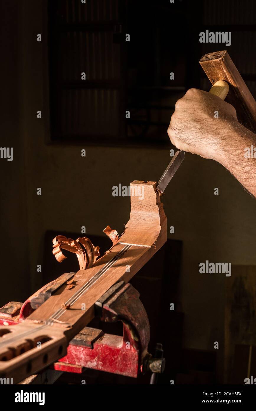 Luthier making a neck of acoustic guitar Stock Photo - Alamy