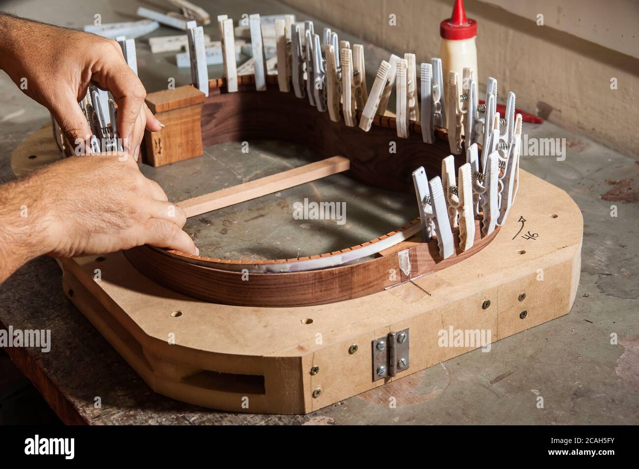 Luthier making an acoustic guitar body Stock Photo - Alamy