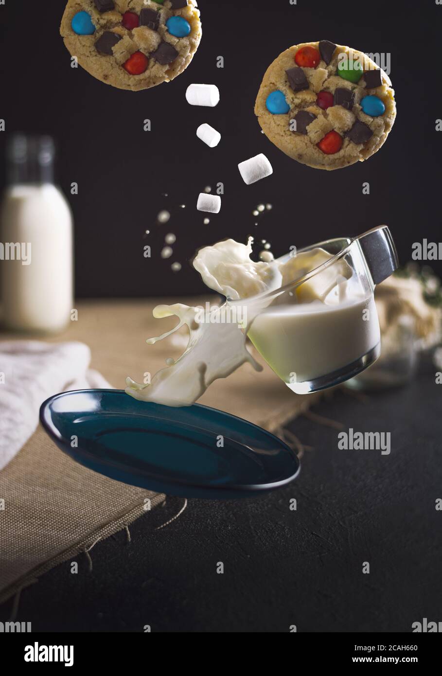 Chocolate chip cookies and the marshmallows falling into the glass of ...