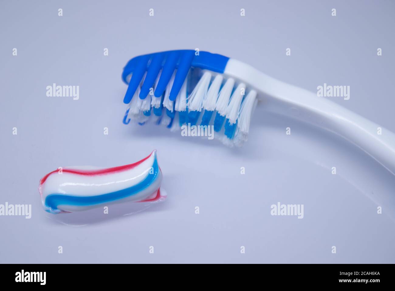 toothbrush on a white background next to the toothpaste. healthy and ...