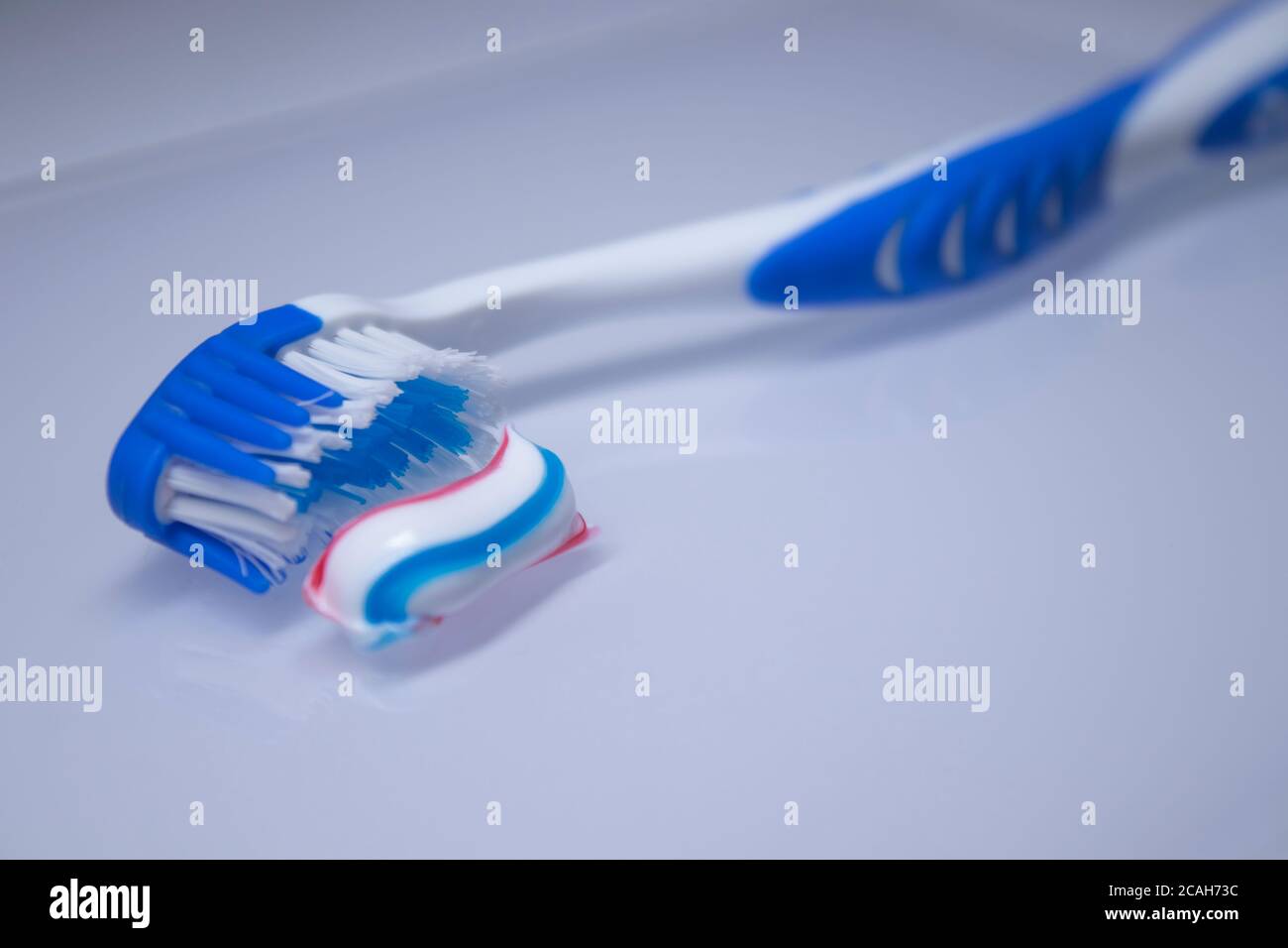 toothbrush on a white background next to the toothpaste. healthy and ...