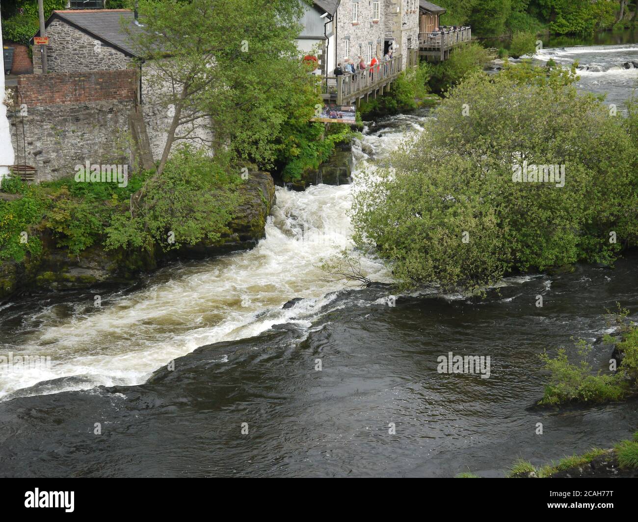 Fast-Flowing River through a Rural Town Stock Photo - Alamy