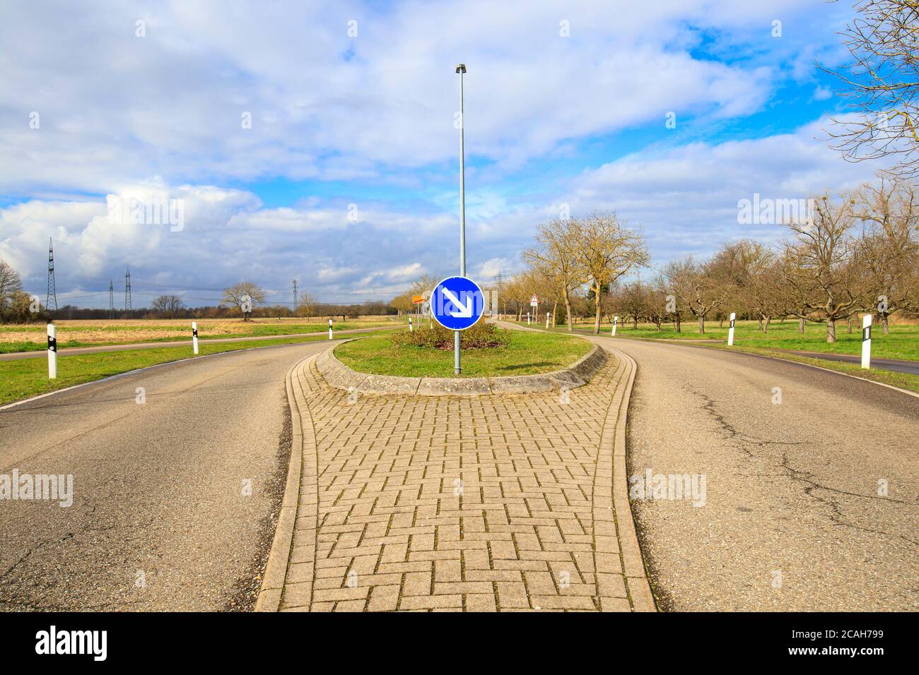 Traffic island with an arrow Stock Photo - Alamy