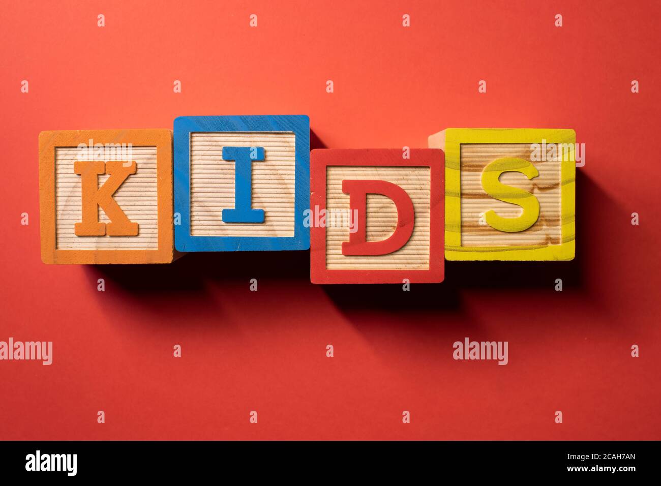 Word Kids written with wooden colored cubes Stock Photo - Alamy