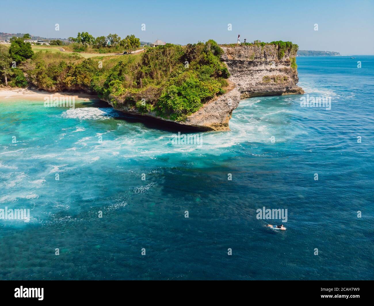 Surfing waves in blue ocean and cliff at background. Aerial view of ...