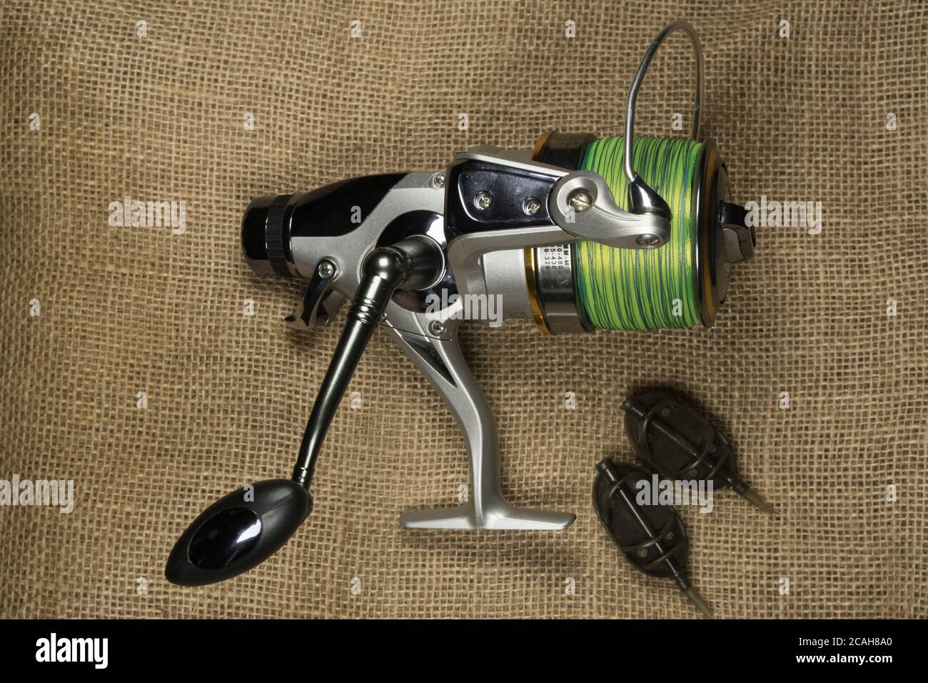 Fishing troughs and fish bait on burlap background. Set of fish feeders ...