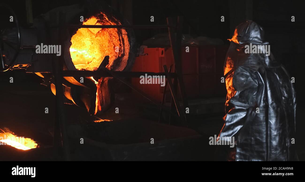Smelting orange metal in a metallurgical plant. Liquid iron from the ...