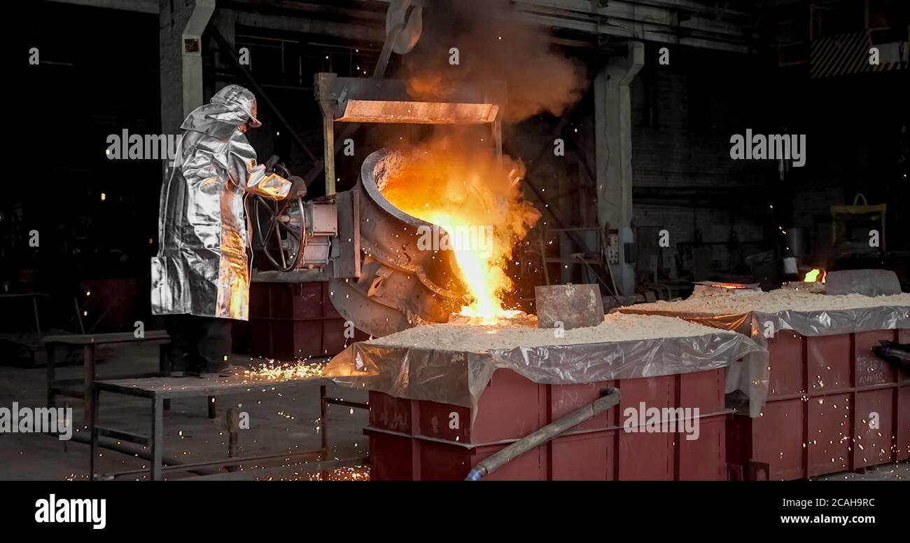 Smelting metal in a metallurgical plant. Liquid iron in the ladle in ...