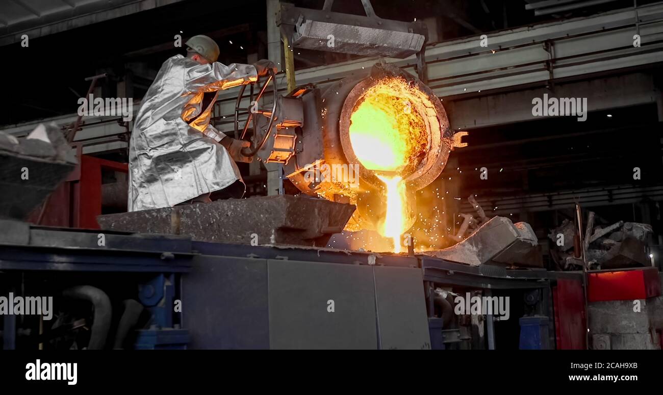 Smelting metal in a metallurgical plant. Liquid iron in the ladle in ...