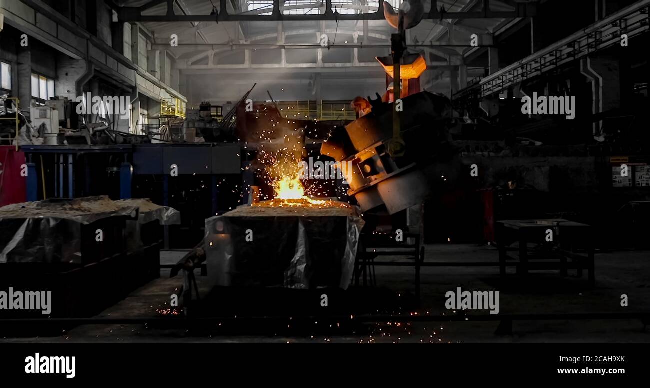 Smelting metal in a metallurgical plant. Liquid iron in the ladle in ...