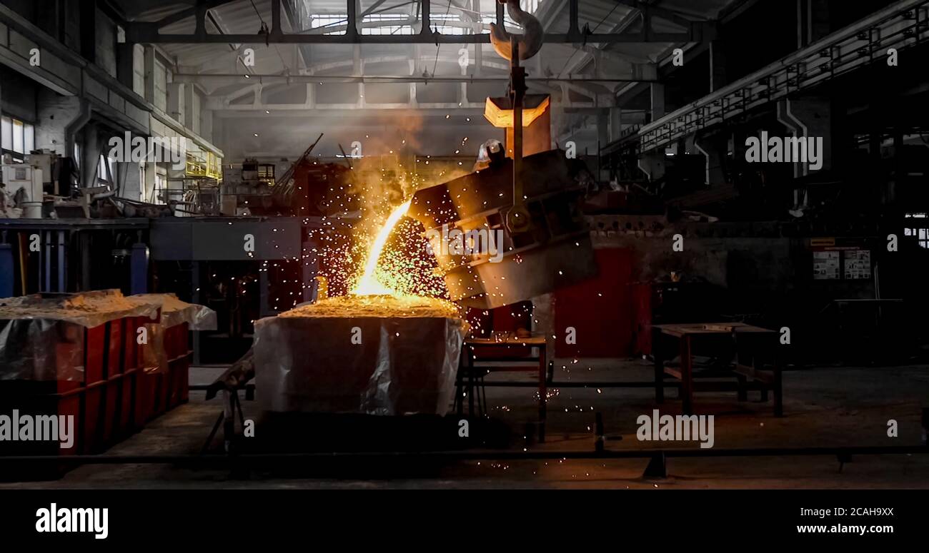Smelting metal in a metallurgical plant. Liquid iron in the ladle in ...