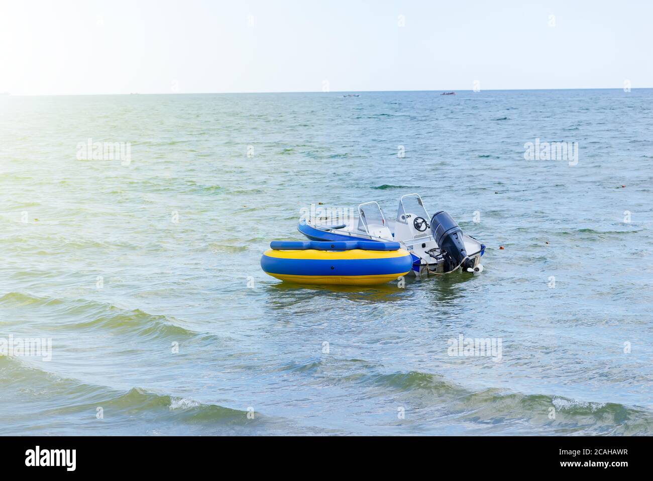 Seawater surface with inflatable water ride boat and scooter without ...