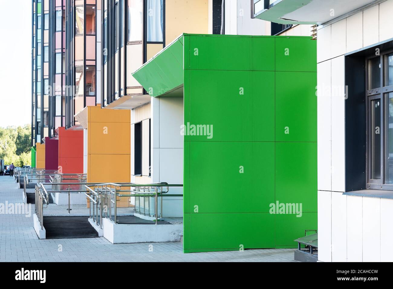 Part of the multi-colored facade of a multi-storey residential building ...