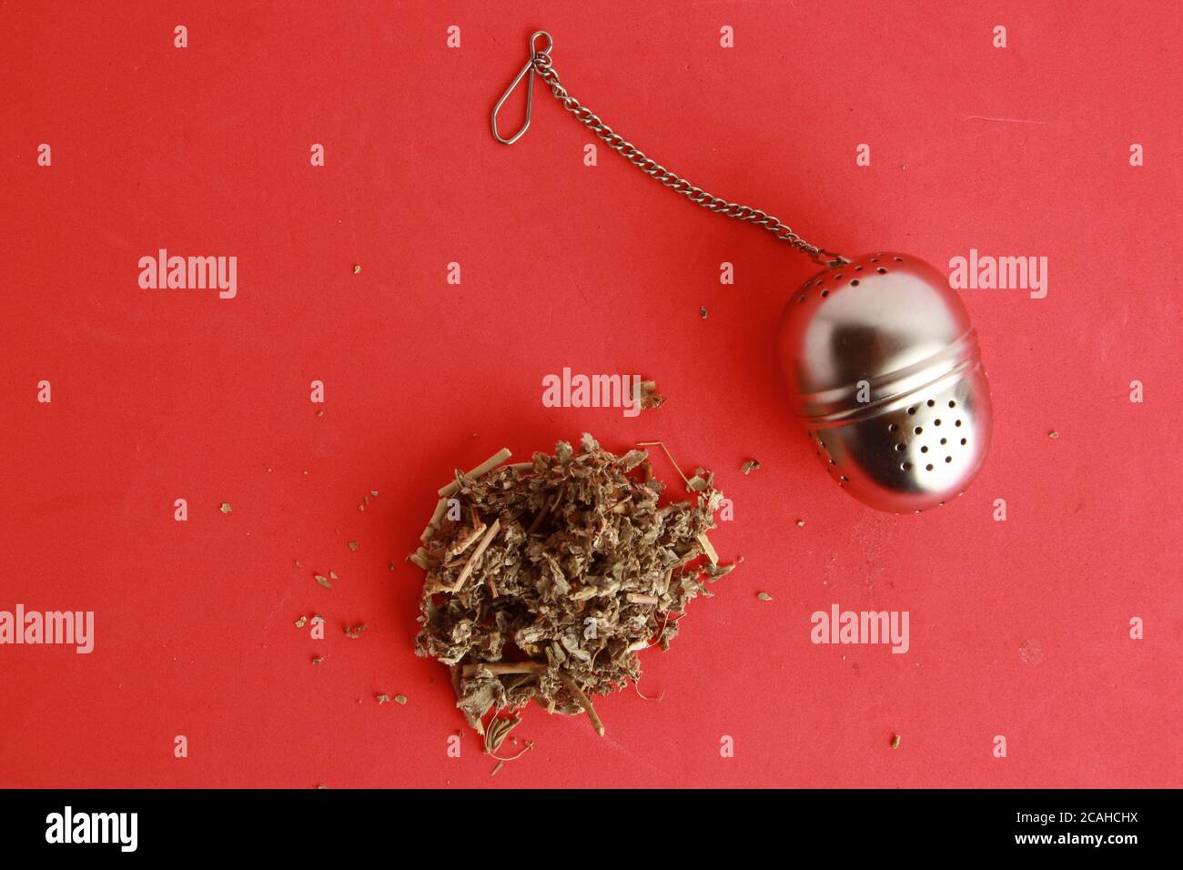 Closeup shot of infusion of raspberry leaves on a red background Stock ...