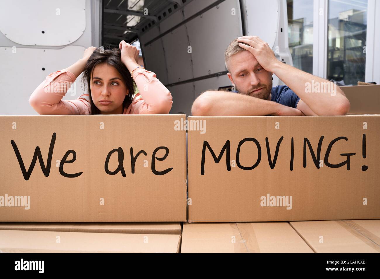 Home Move Stress. Frustrated Couple Moving Apartment Stock Photo - Alamy