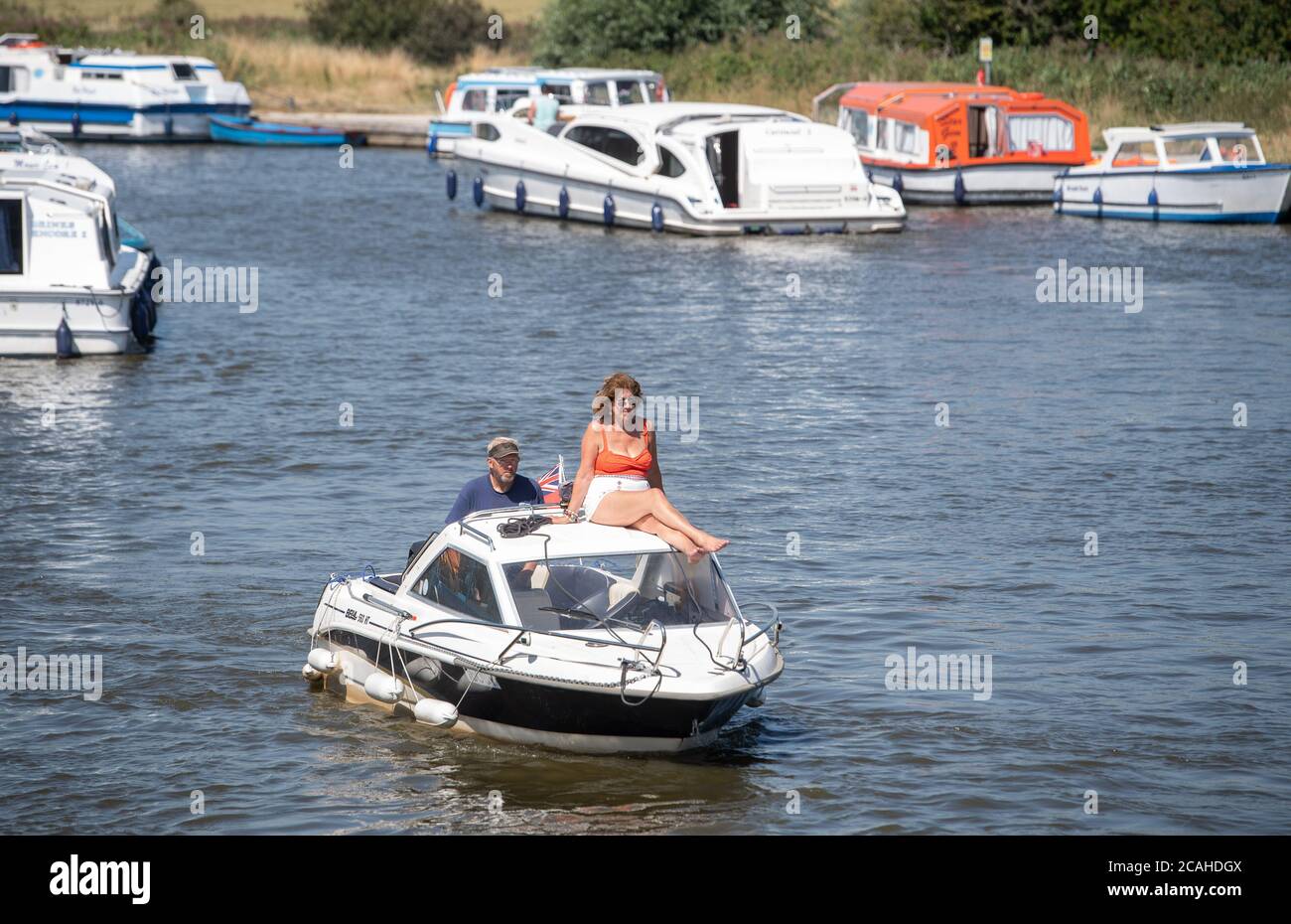 Pleasure boats make their way along the River Ant at Ludham Bridge on ...