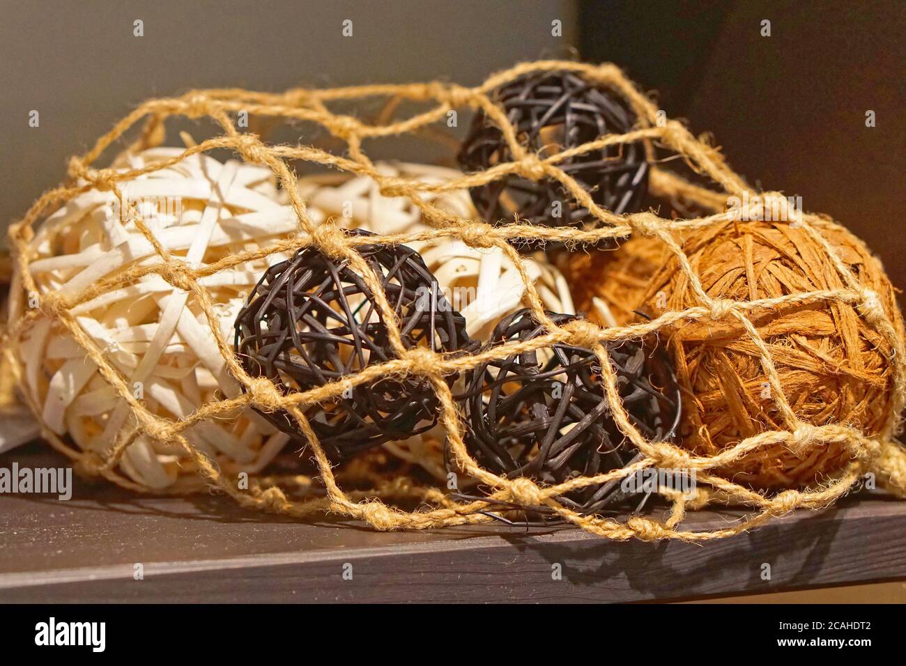 Decorative wicker rattan balls in rope net Stock Photo - Alamy