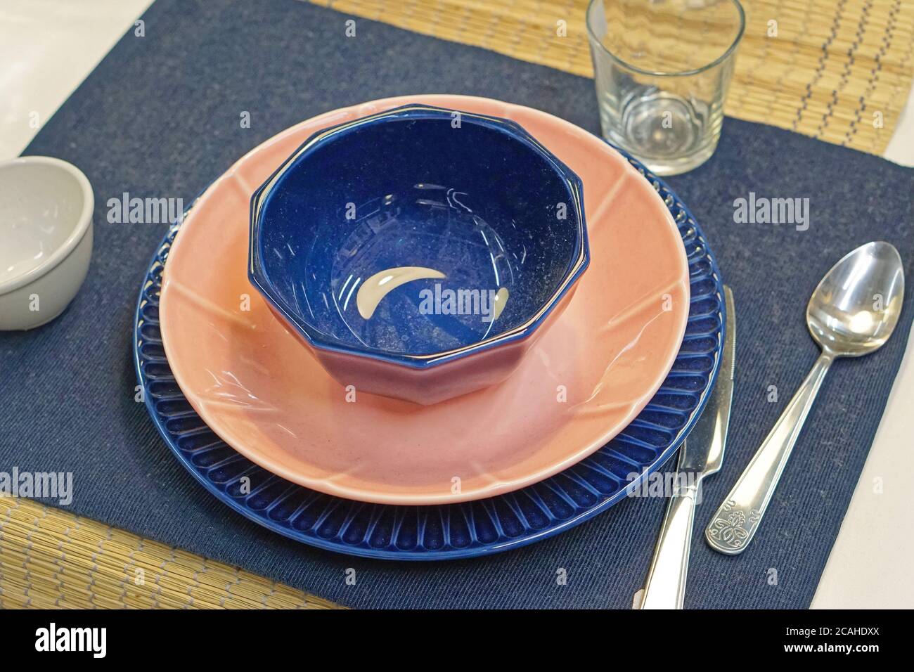 Modern bowl and plates dining table for one Stock Photo - Alamy