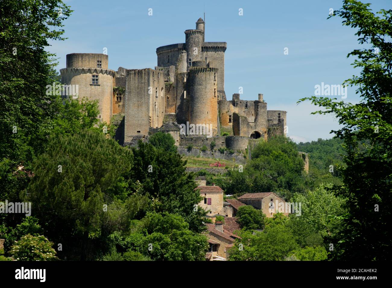 The Chateau de Bonaguil sitting above the village of Bonaguil, near ...