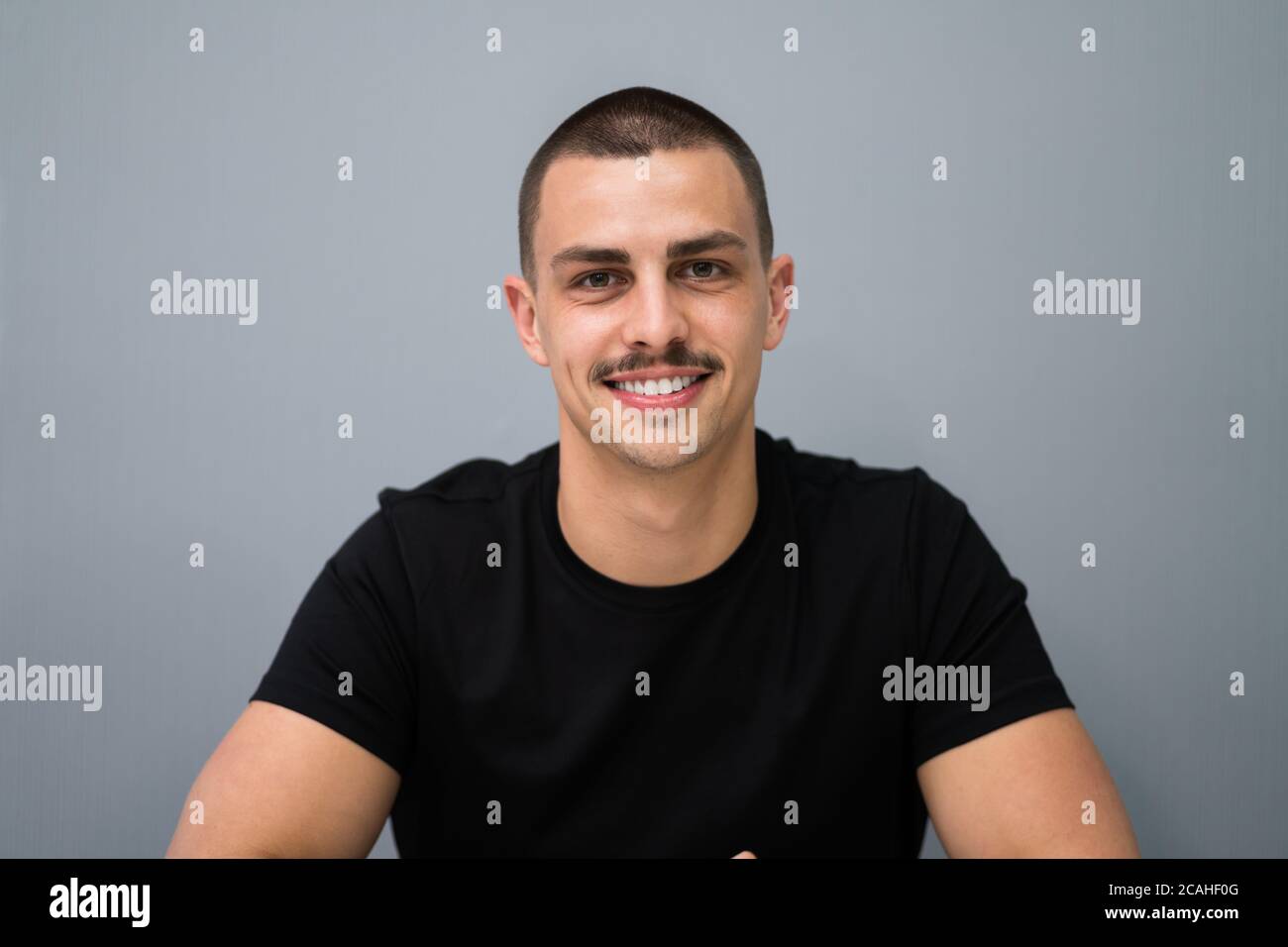 Smiling Young Man Portrait At Workplace In Office Stock Photo - Alamy