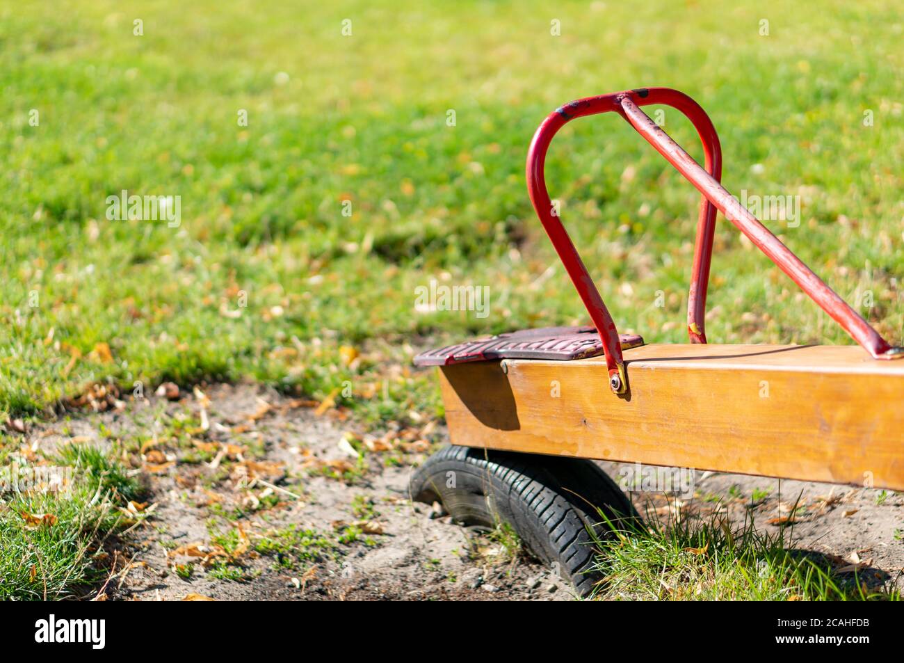 Selective focus shot of wooden seesaw with still handle on the ground ...