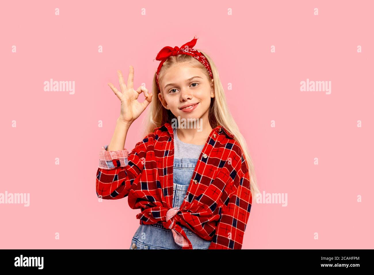 Kid girl showing ok sign, looking at camera Stock Photo - Alamy