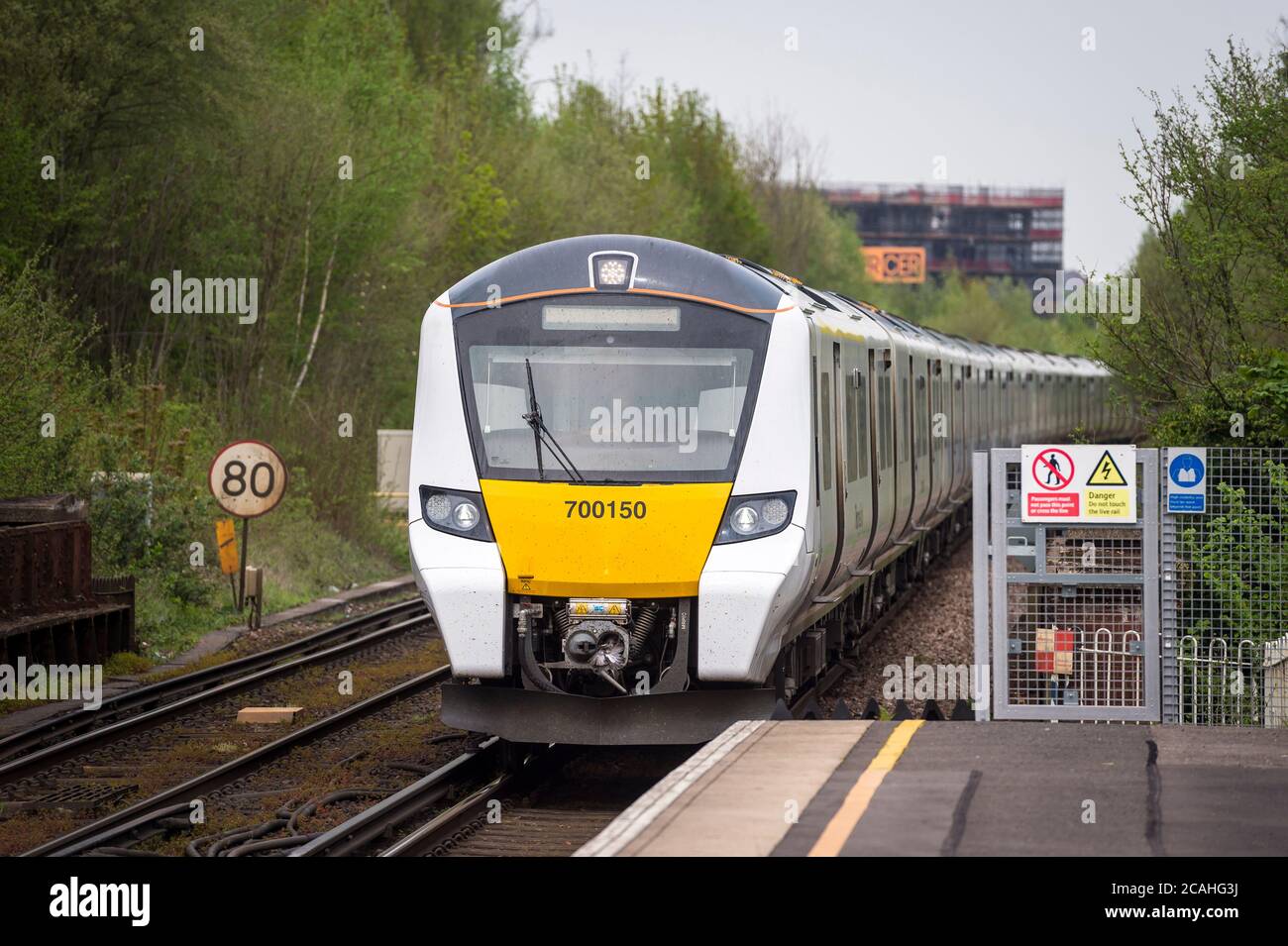 Class 700 passenger train in Thameslink livery approaching a railway ...