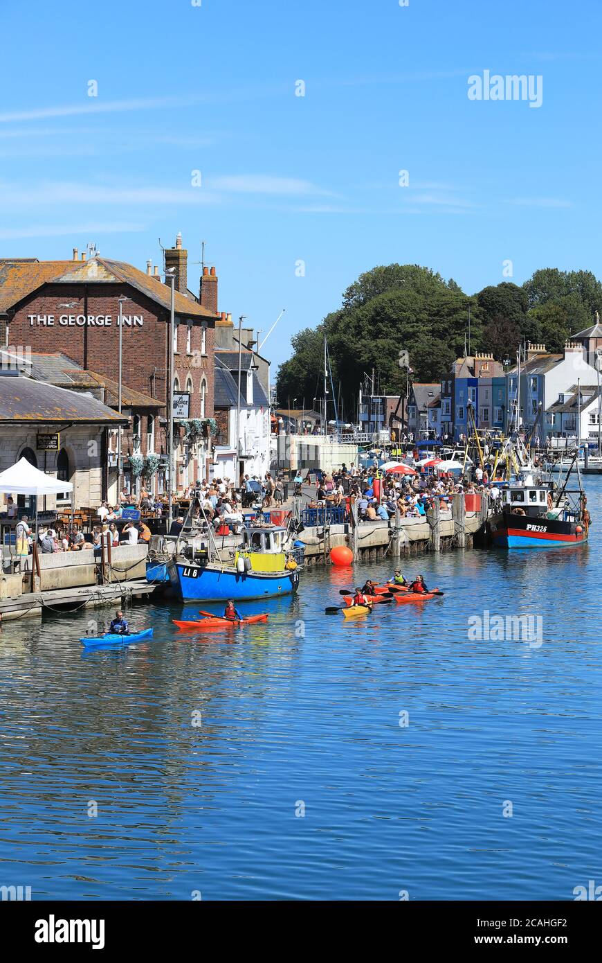 The pretty Old Harbour in Weymouth, Dorset, on a busy summer's day, on ...
