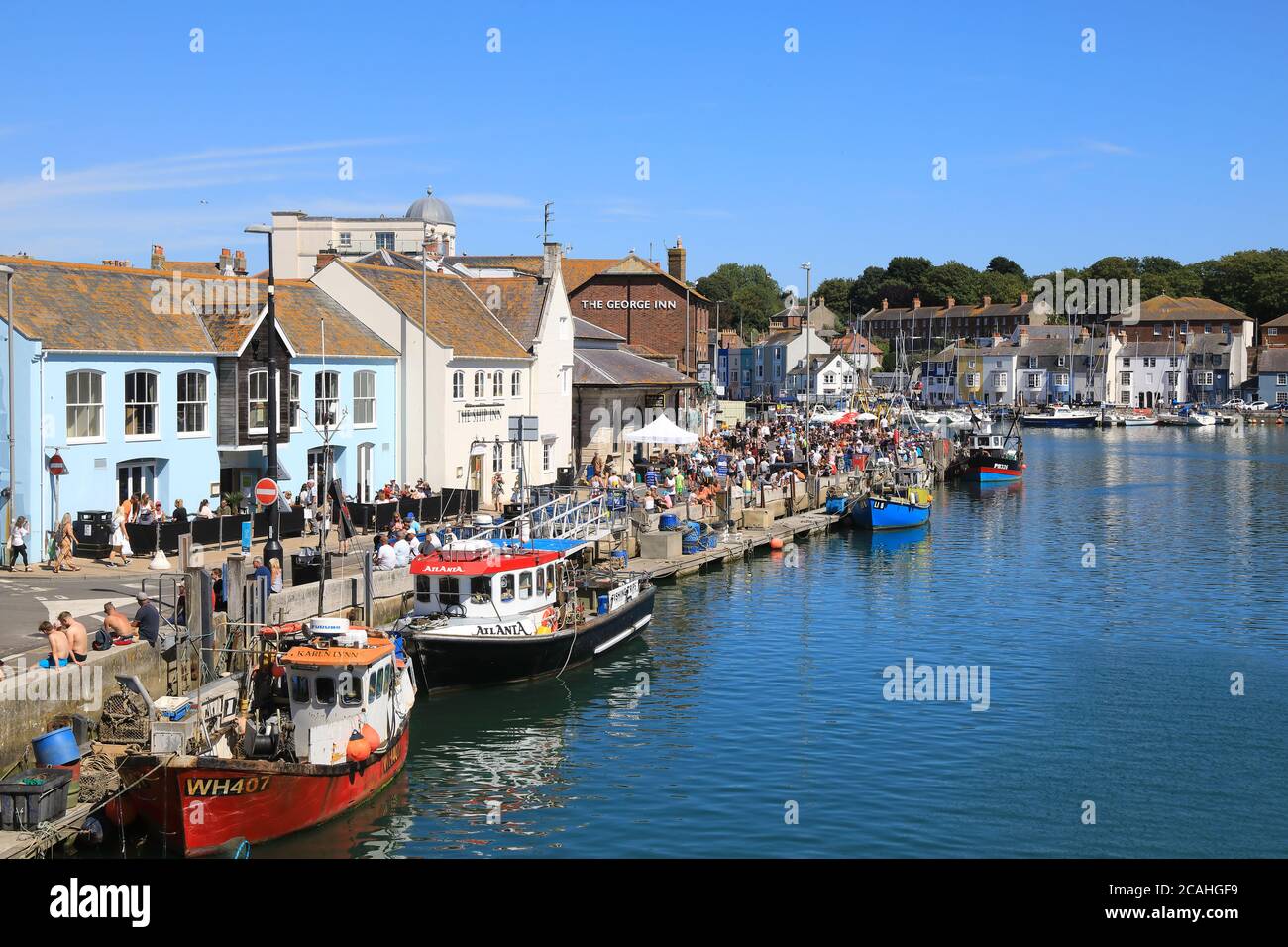 The pretty Old Harbour in Weymouth, Dorset, on a busy summer's day, on ...