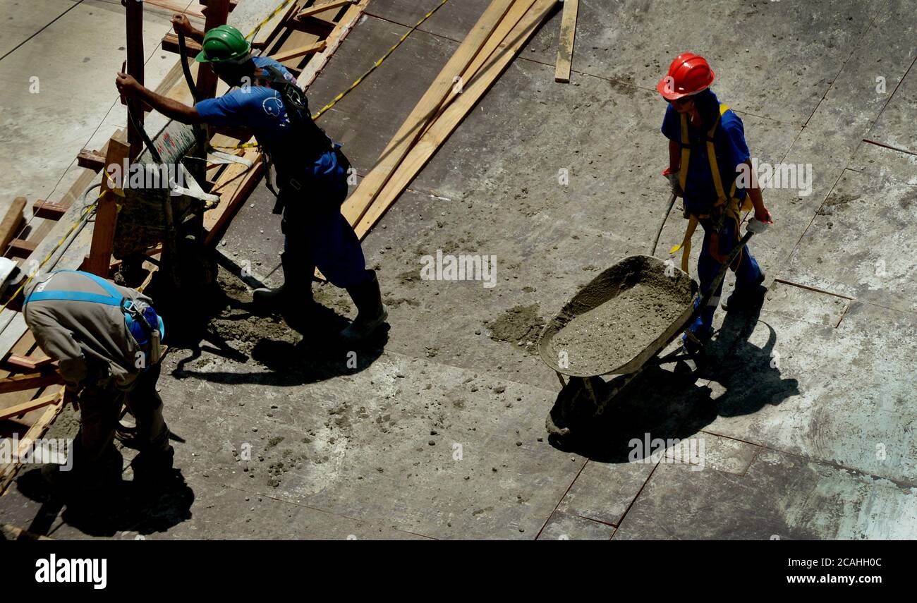 Rio de Janeiro, Brazil November 13th, 2018 Workers transport cement as ...