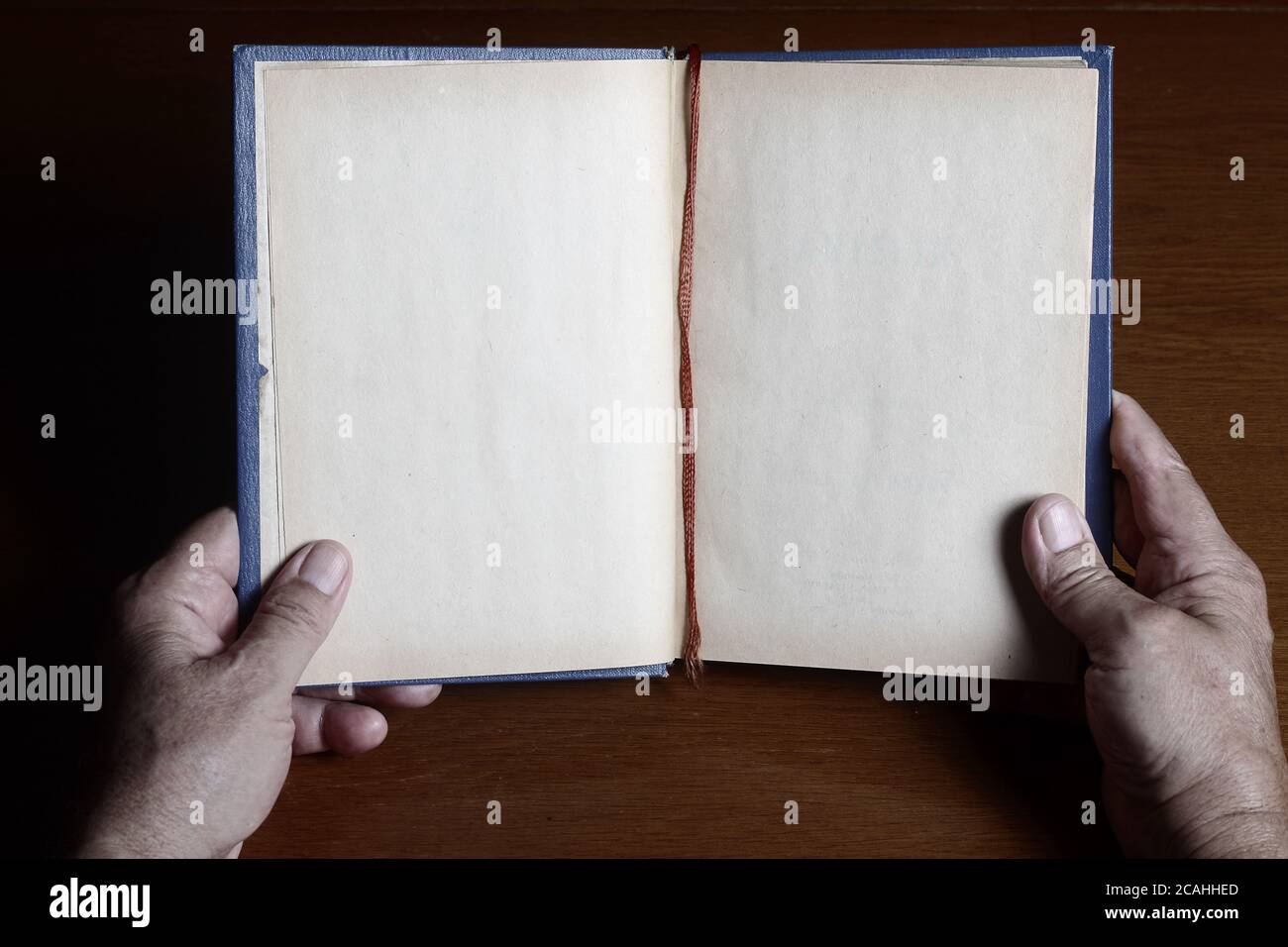 open book with hand on wooden background. Conceptual composition about ...