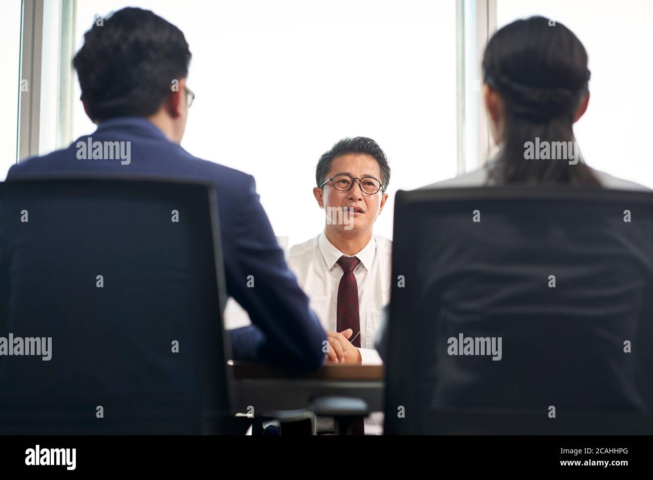 older asian business man job seeker being interviewed by young human ...