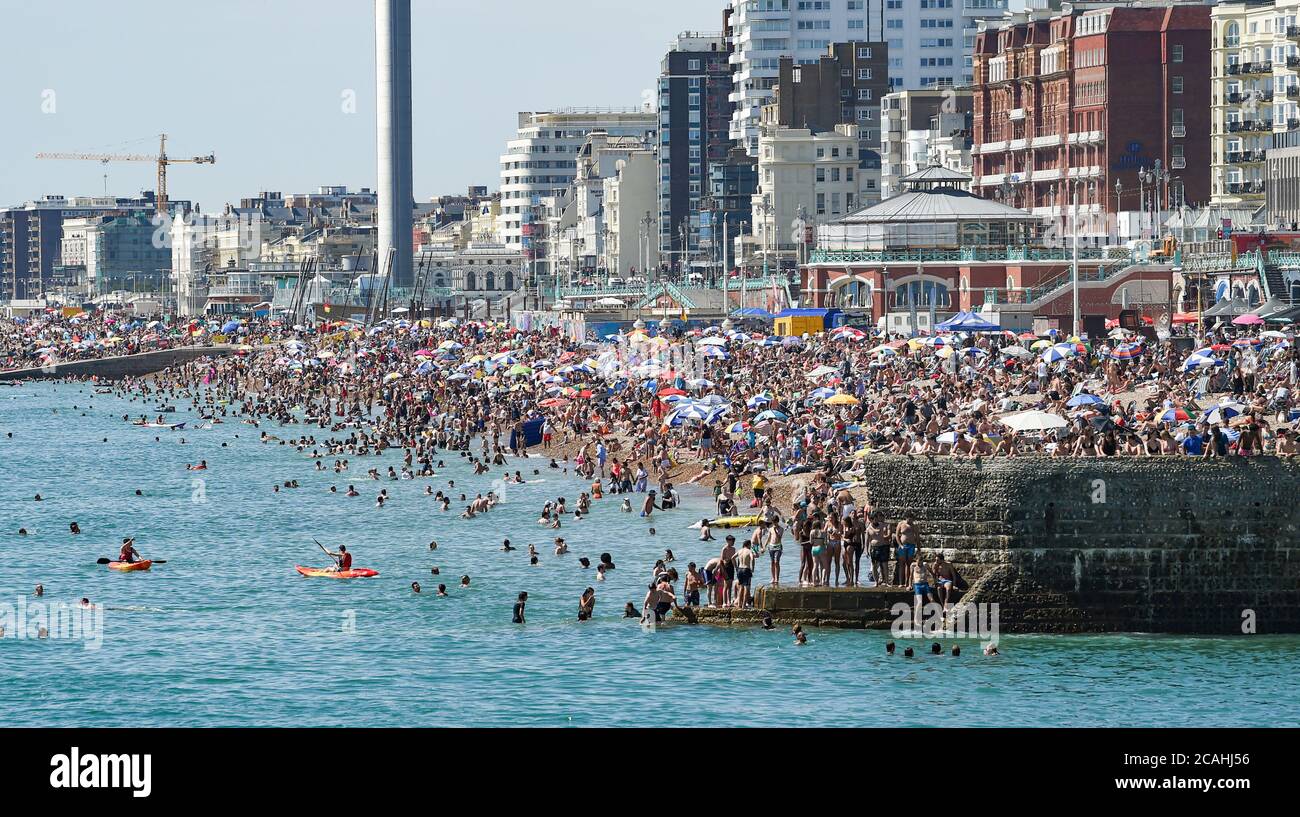 Brighton UK 7th August 2020 - Crowds flock to Brighton beach as they ...
