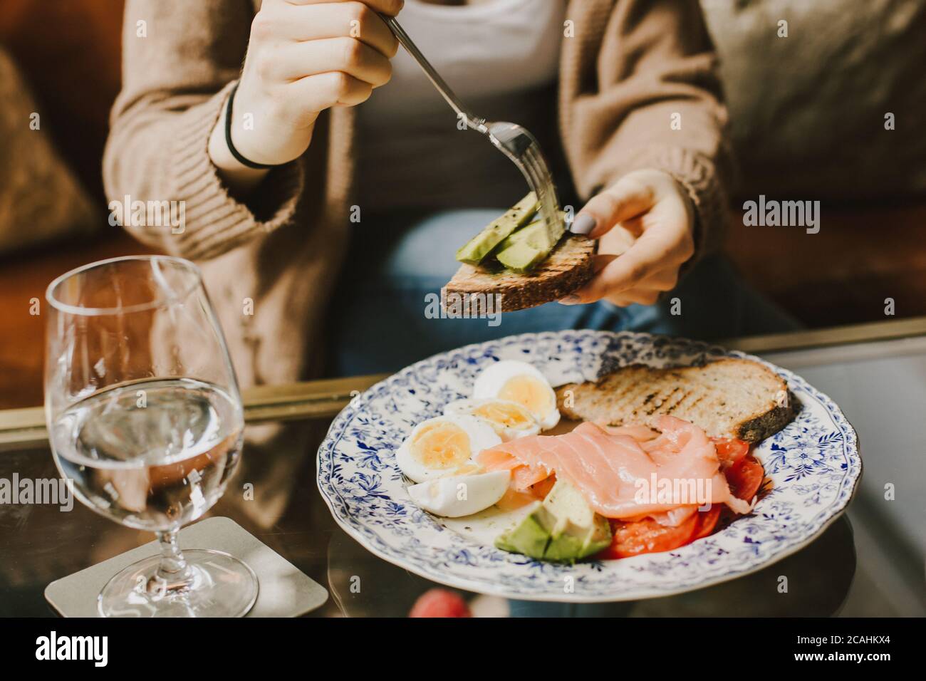 Girl at brunch in the city drinking iced coffee and eating a delicious ...