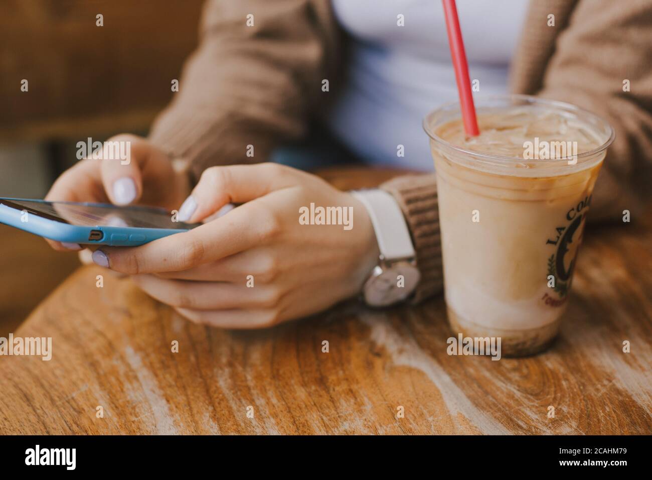 Girl at brunch in the city drinking iced coffee and eating a delicious ...