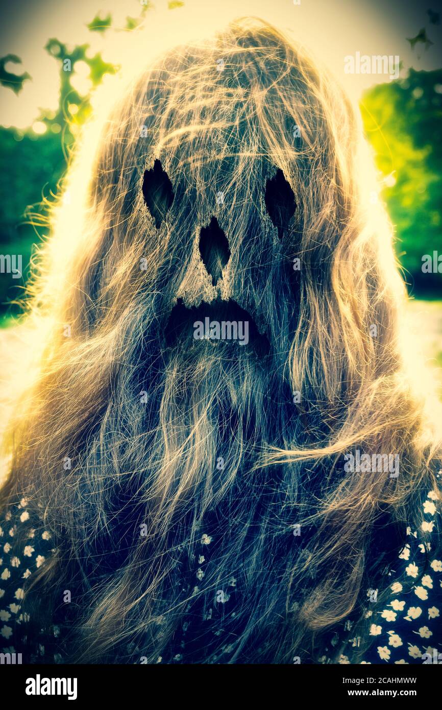 Monster face on the back of a woman's hair Stock Photo - Alamy